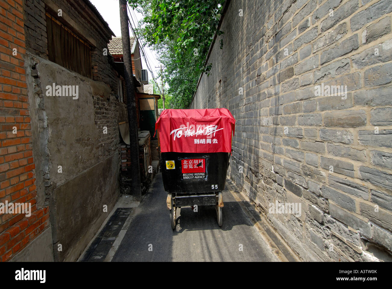 Chinese rickshaw riding through narrow lanes of Beijing Hutong China ...
