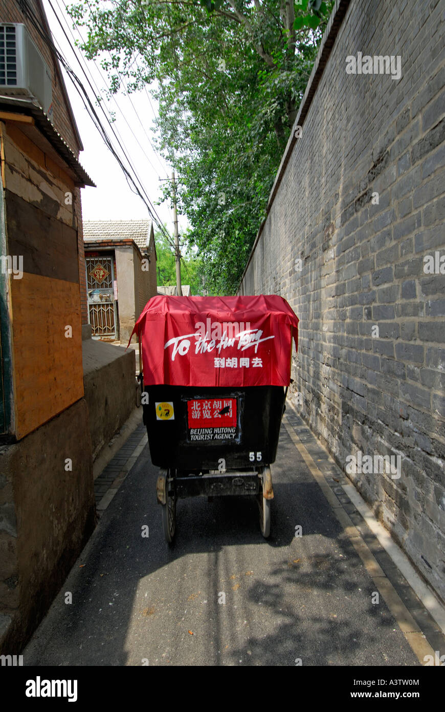 Chinese rickshaw riding through narrow lanes of Beijing Hutong China ...