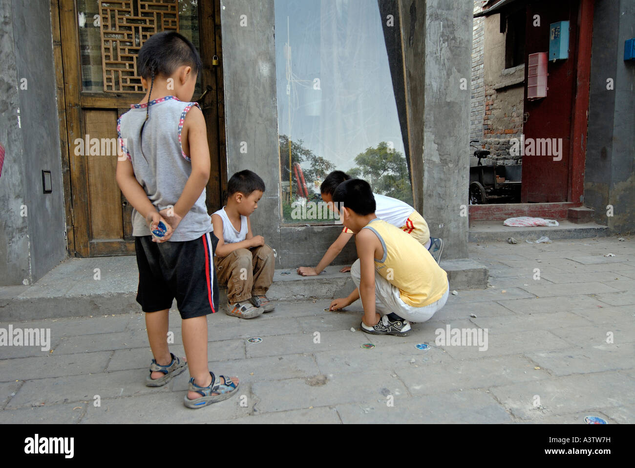Chinese boys playing in the streets of Beijing Hutong China Stock Photo ...