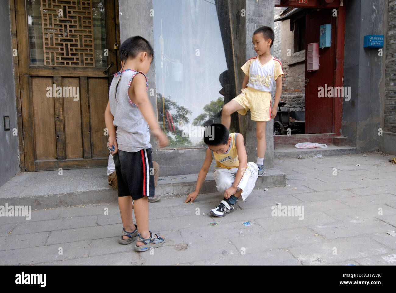 Chinese boys playing in the streets of Beijing Hutong China Stock Photo ...