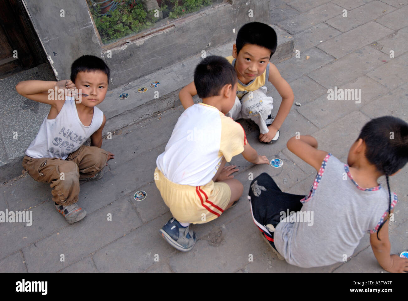 Chinese boys playing in the streets of Beijing Hutong China Stock Photo ...