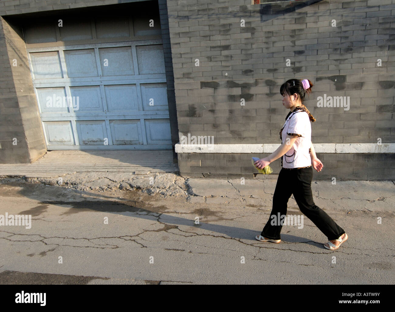 Chinese woman walking in Beijing Hutong China Stock Photo - Alamy