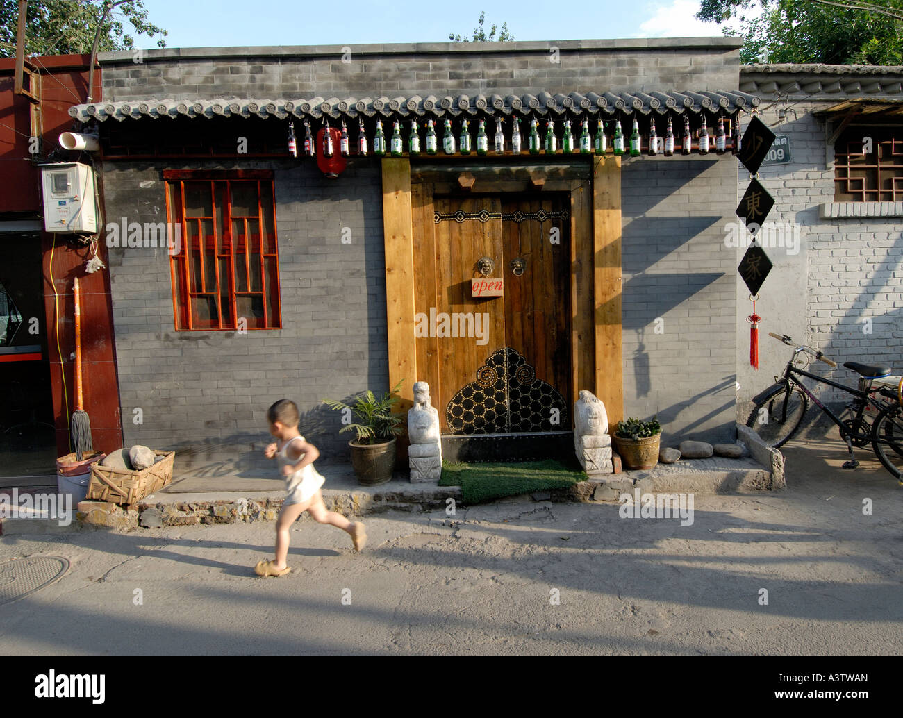 Little boy running in the streets of Beijing Hutong China Stock Photo ...
