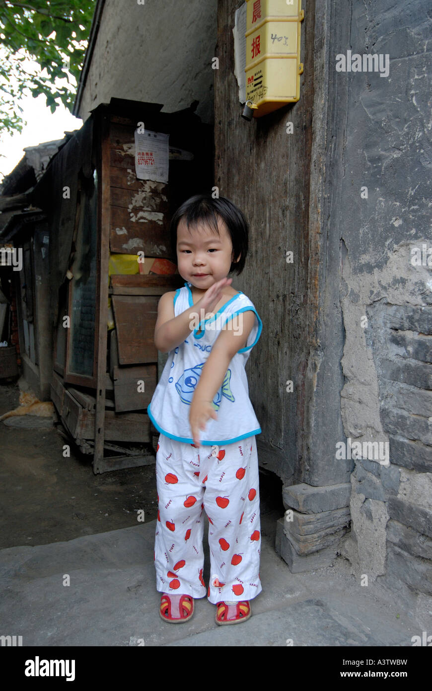 Little Chinese girl with in the narrow lanes of Beijing Hutong China ...