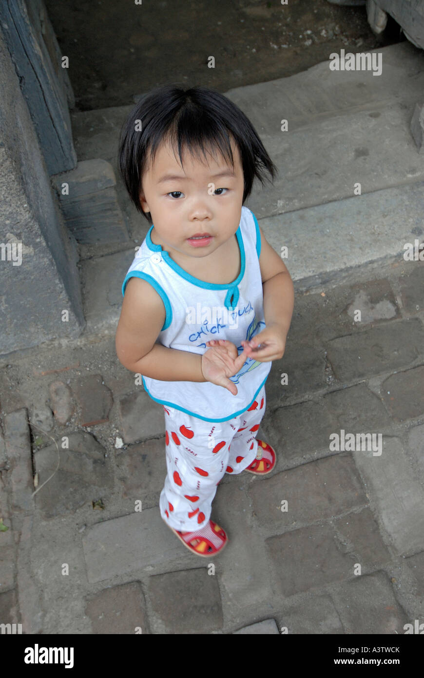 Little Chinese girl with in the narrow lanes of Beijing Hutong China ...
