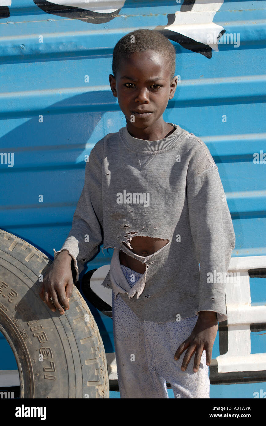Young Kenyan Kenyan boy posing with an old tyre Maralal Northern Kenya ...