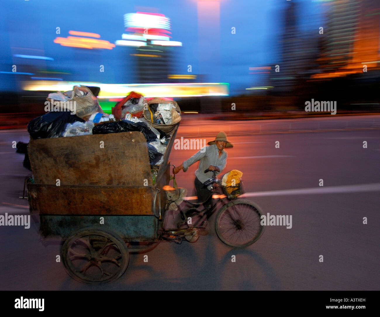 Kunming in motion Chinese man transporting garbage Yunnan China Stock ...