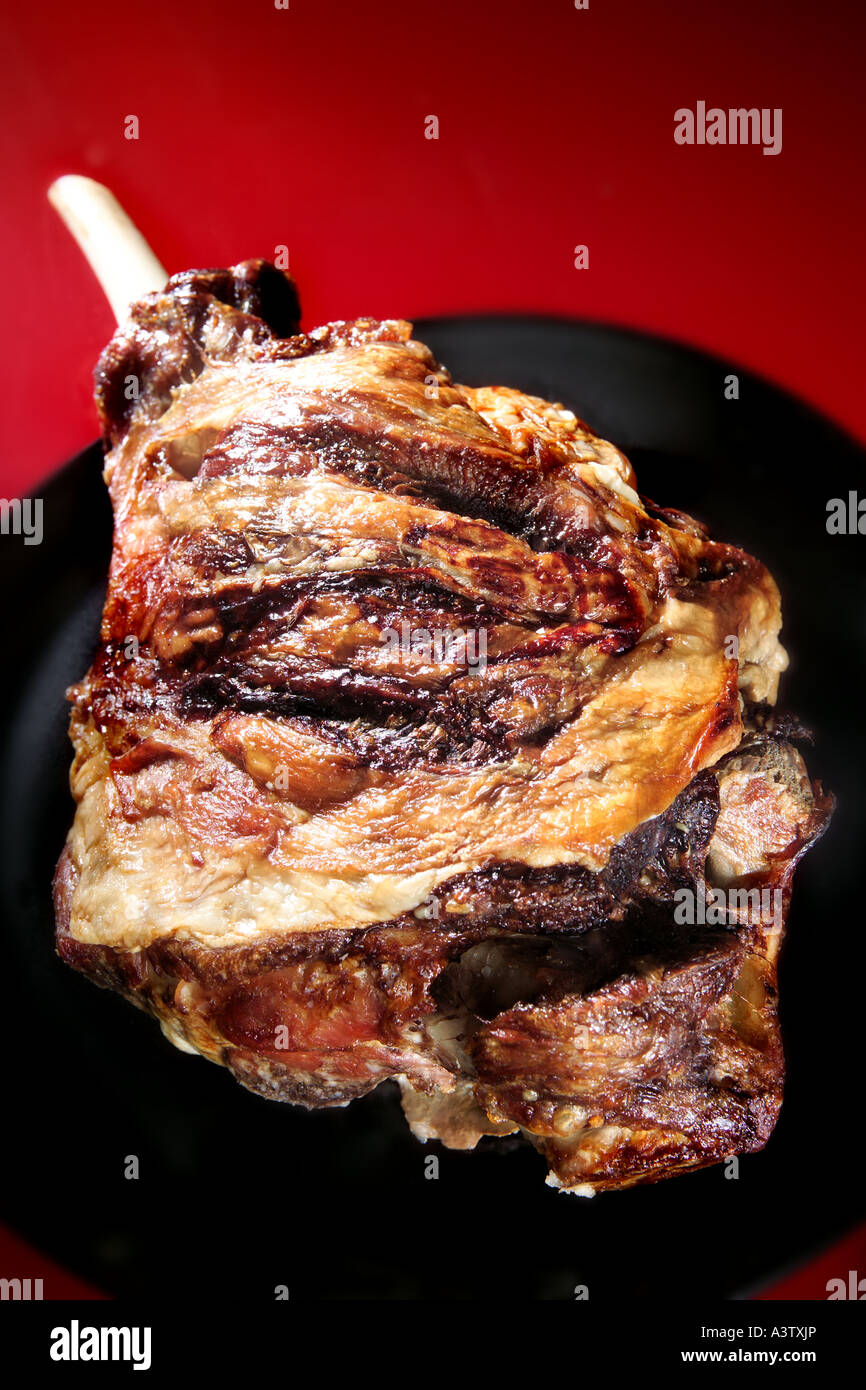 Leg of Lamb Hock Shank Roast with Red Background Stock Photo - Alamy