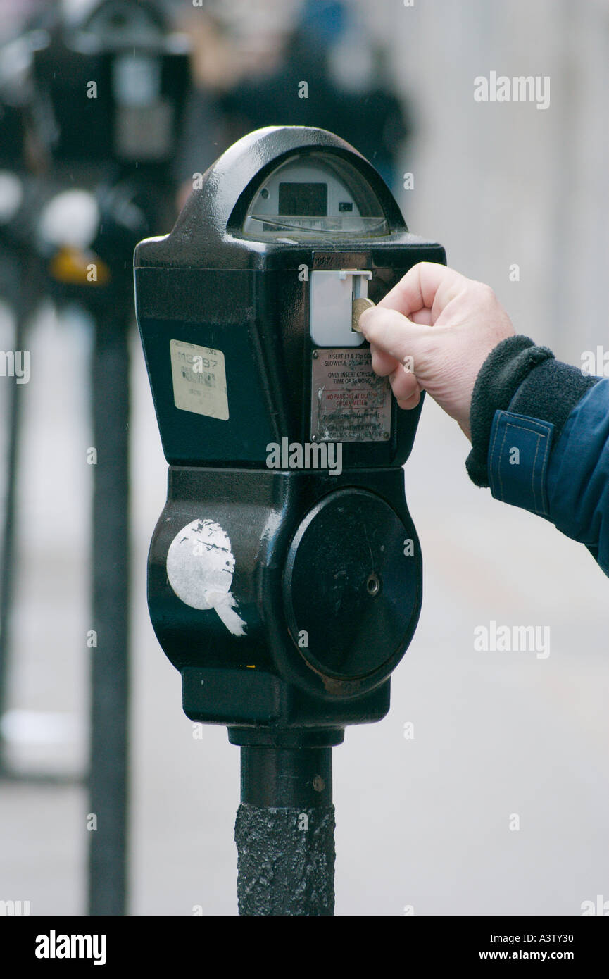 Hand making payment to parking meter in London England Britain UK pay ...