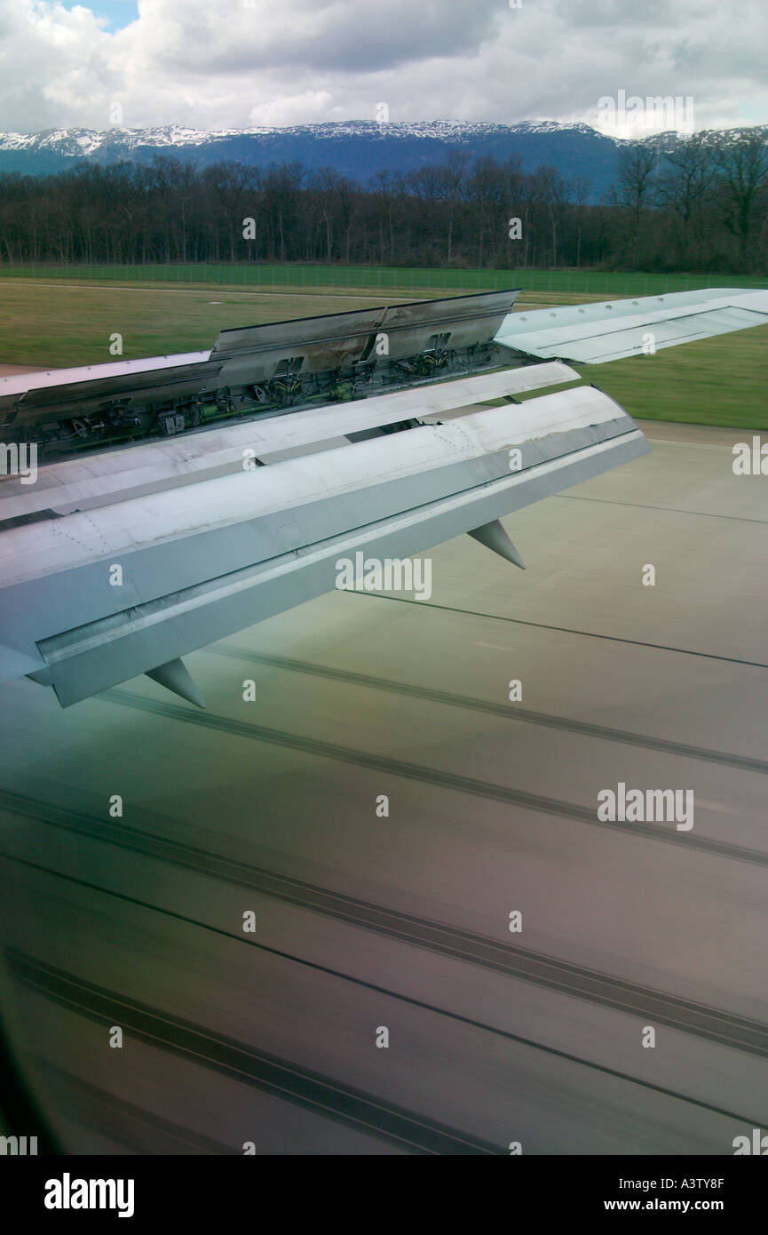 Looking out at plane wing extending its landing flaps Stock Photo - Alamy