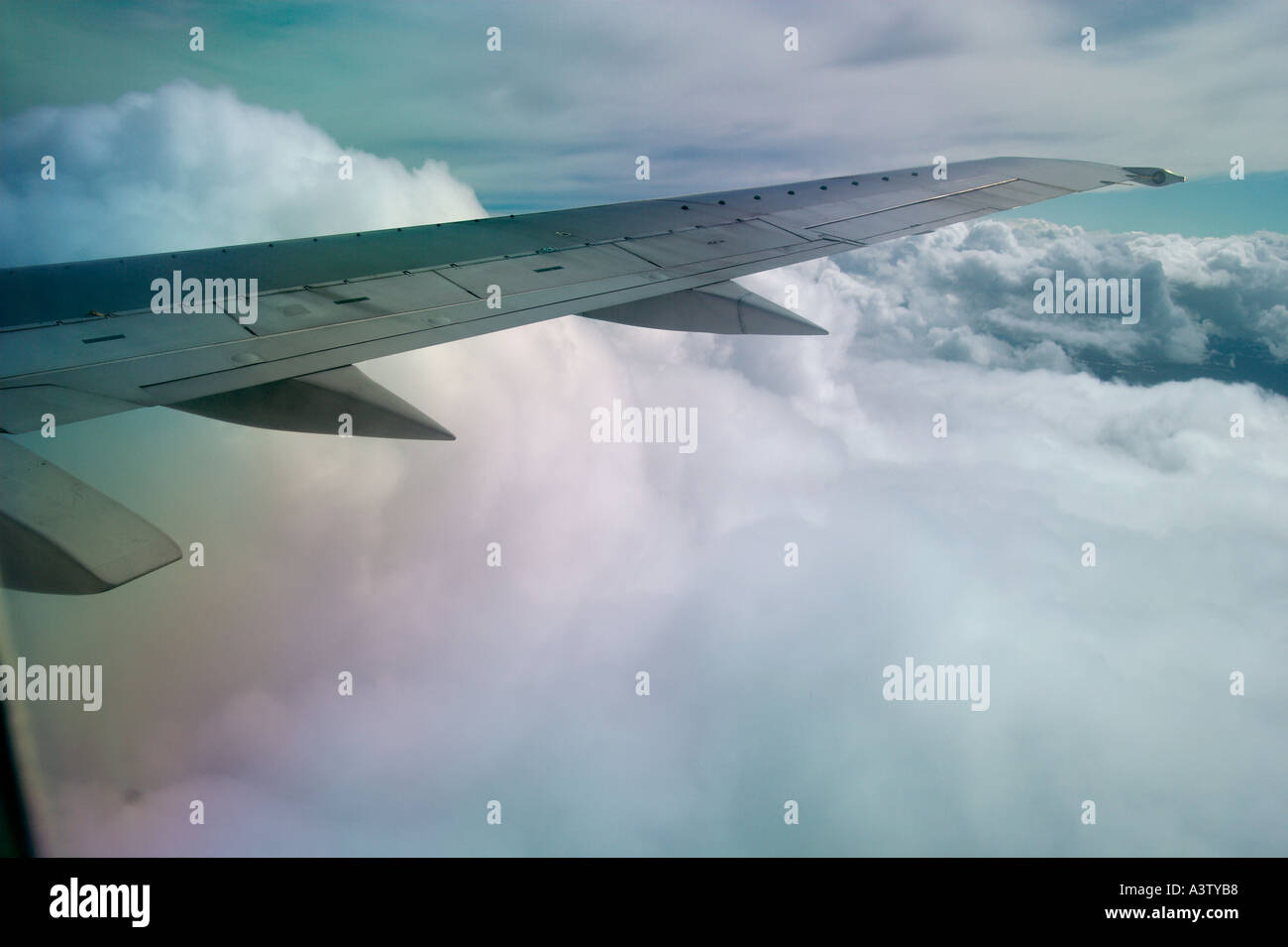 Looking out over plane wing at Clouds Stock Photo - Alamy