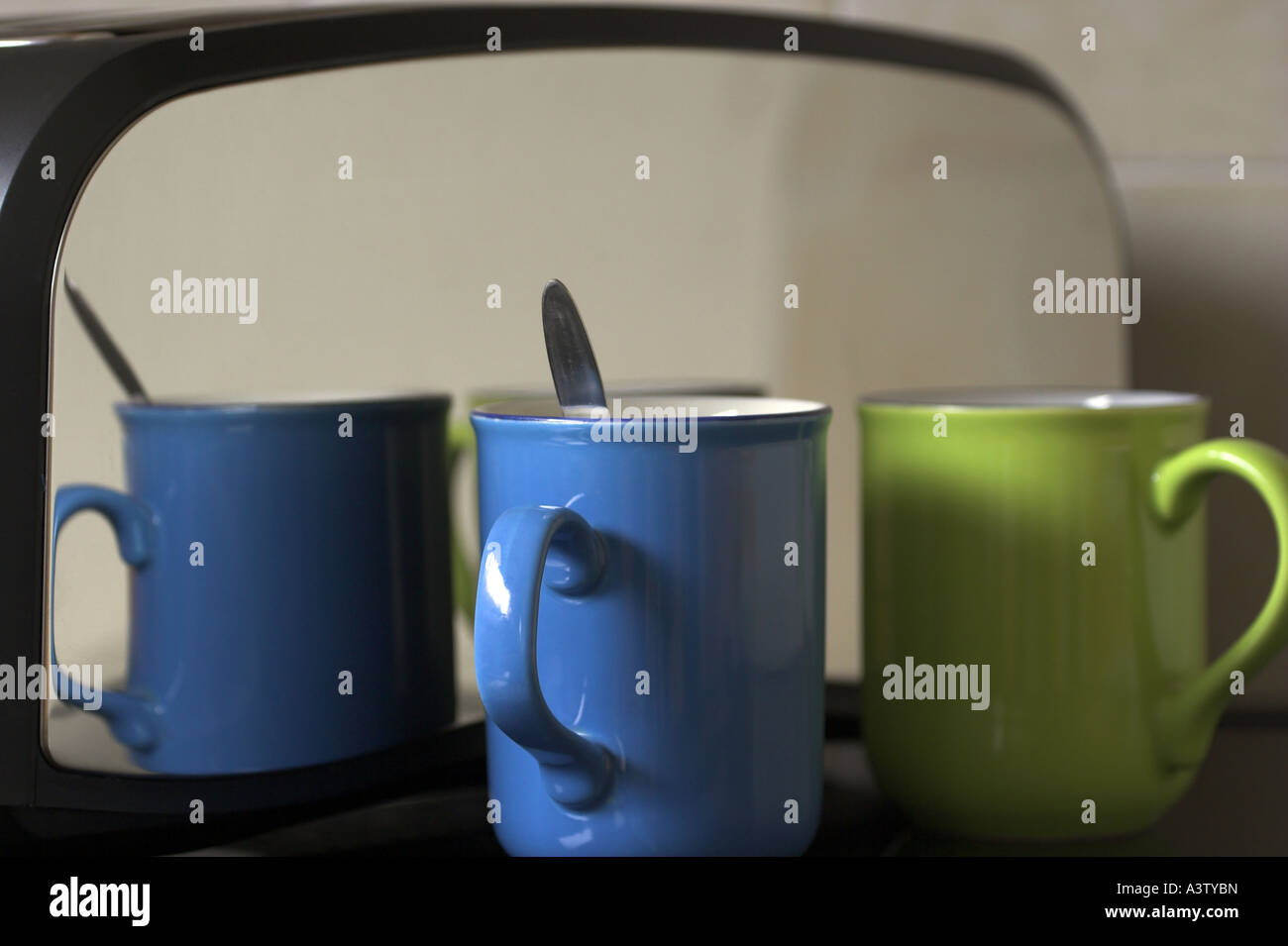 Two cups with reflection in side of electric toaster Stock Photo - Alamy