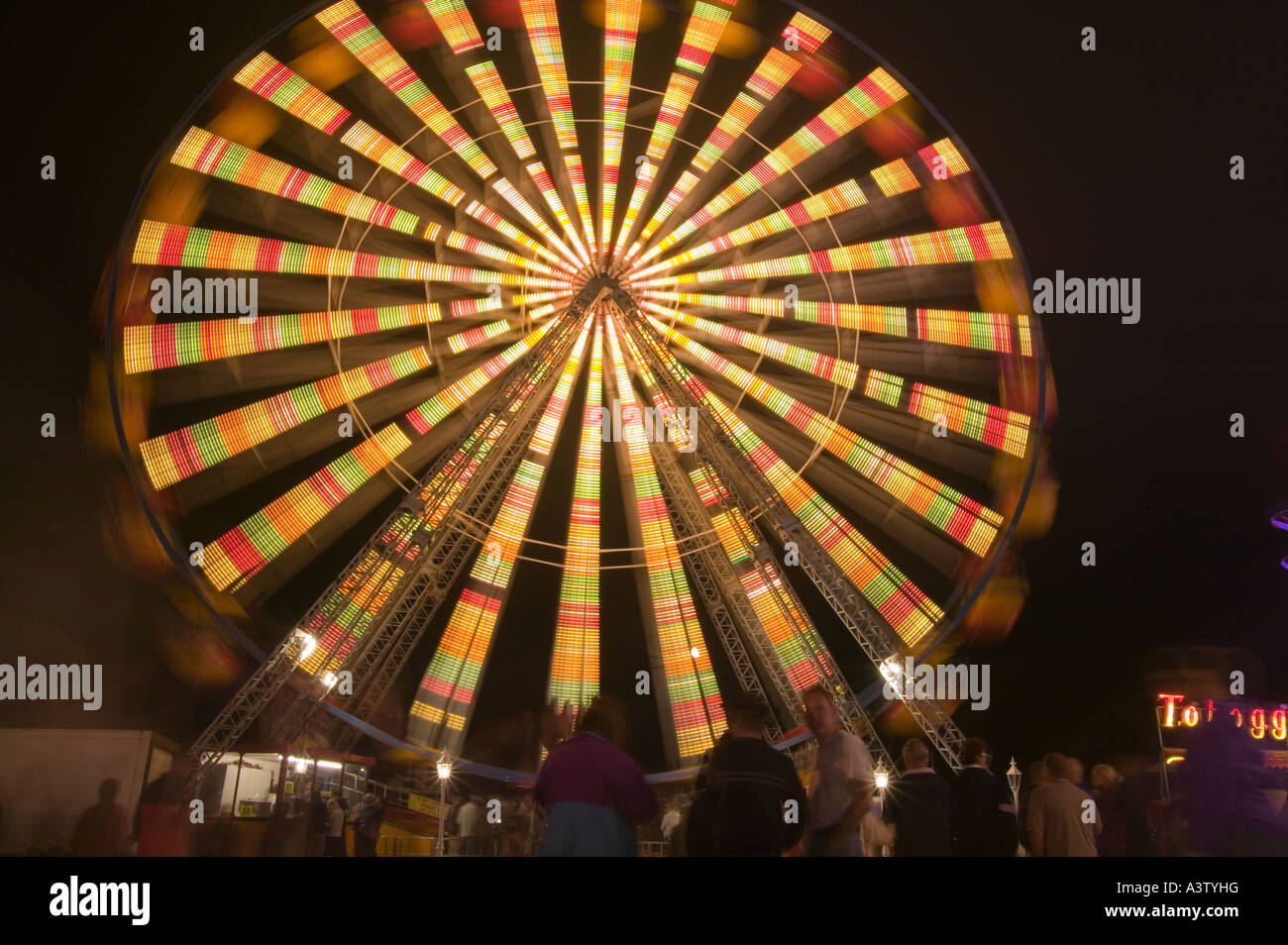 fairground big wheel spinning at night at the Great Dorset Steam Fair ...