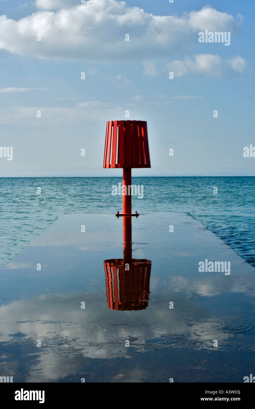 Red jetty marker , sea and reflections of sky Stock Photo - Alamy