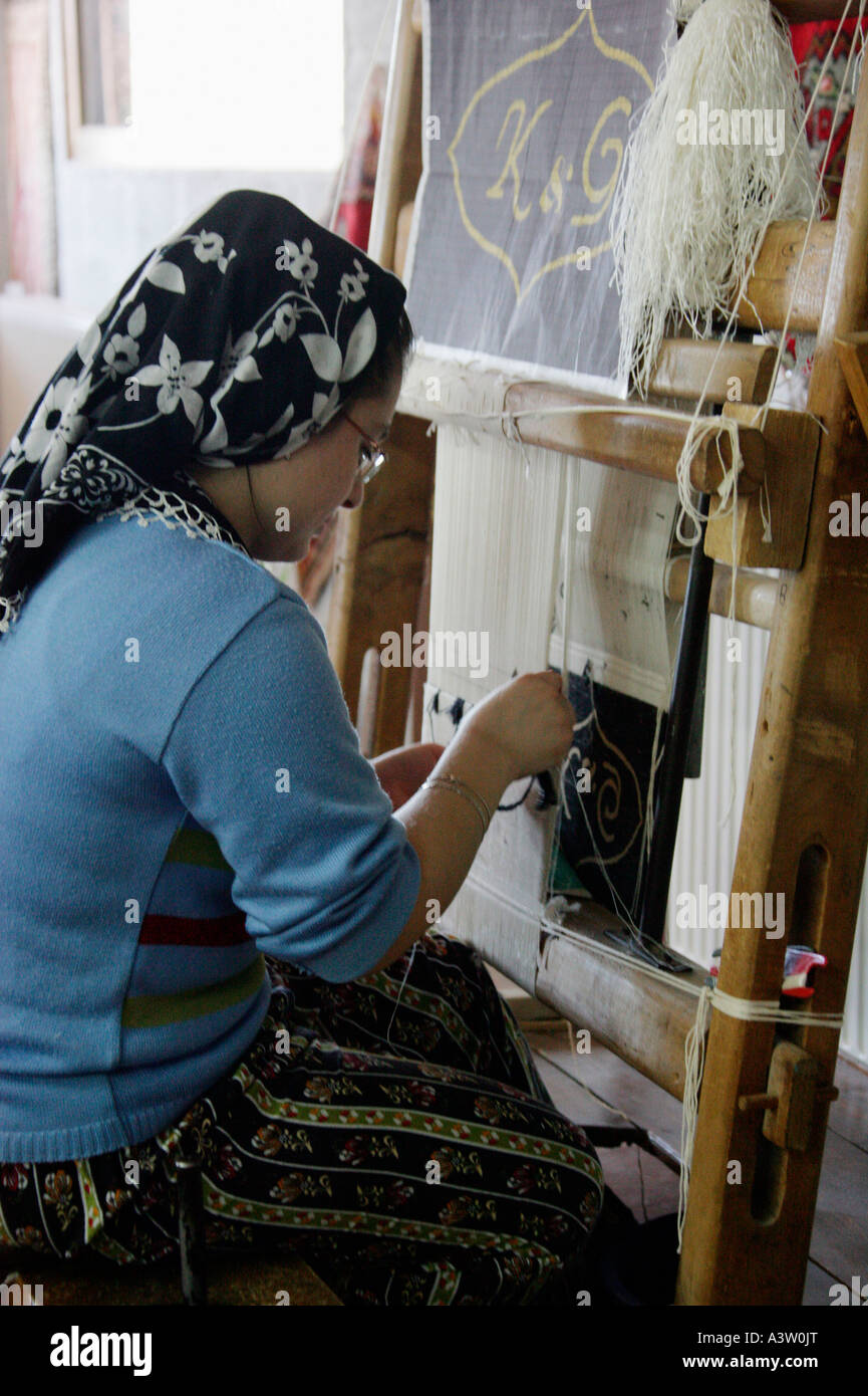 Woman knotting carpet Stock Photo - Alamy