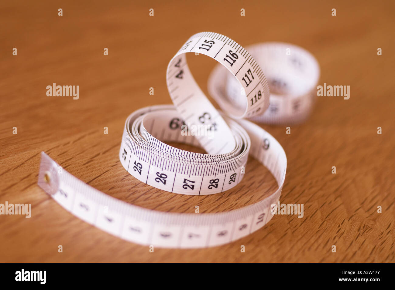 Tape measure on table Stock Photo - Alamy