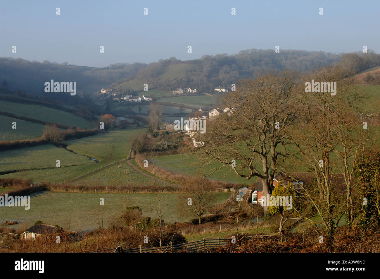 Coastal valley with Branscombe village Devon houses farmland lit by ...