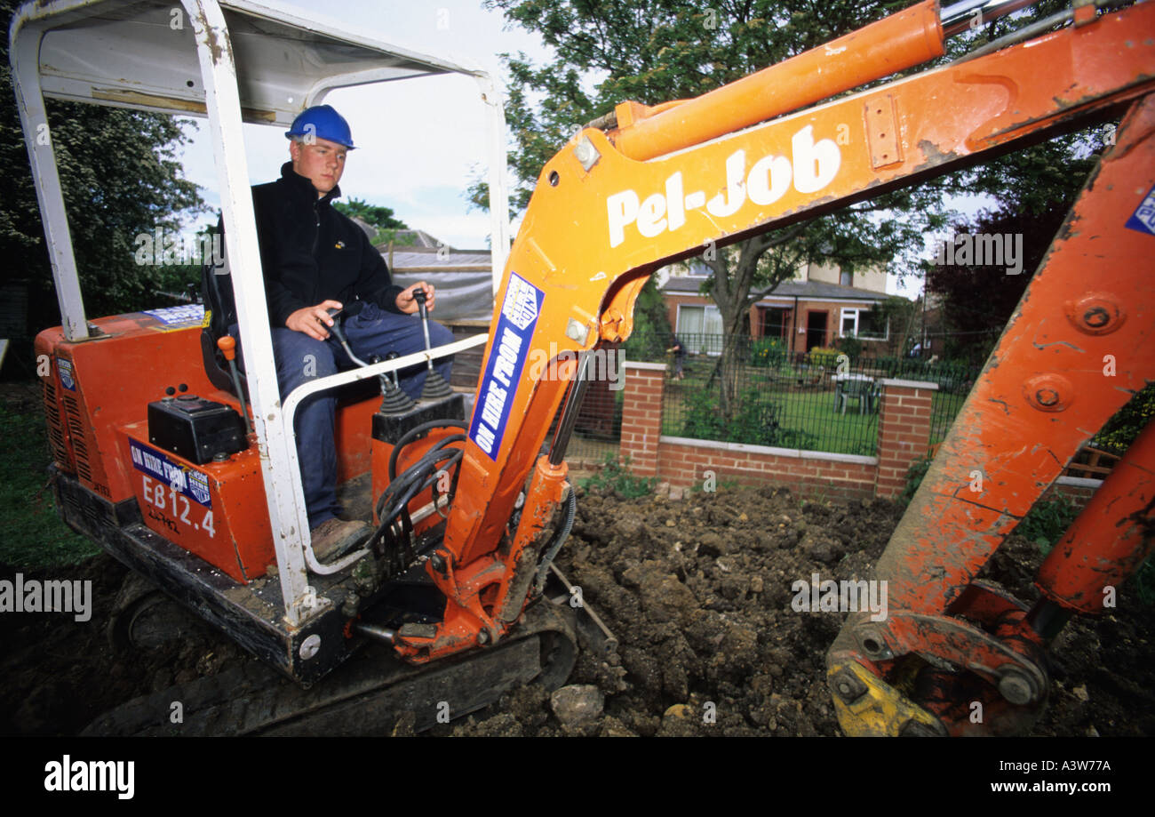 workman operating digger on site in leeds yorkshire uk Stock Photo - Alamy