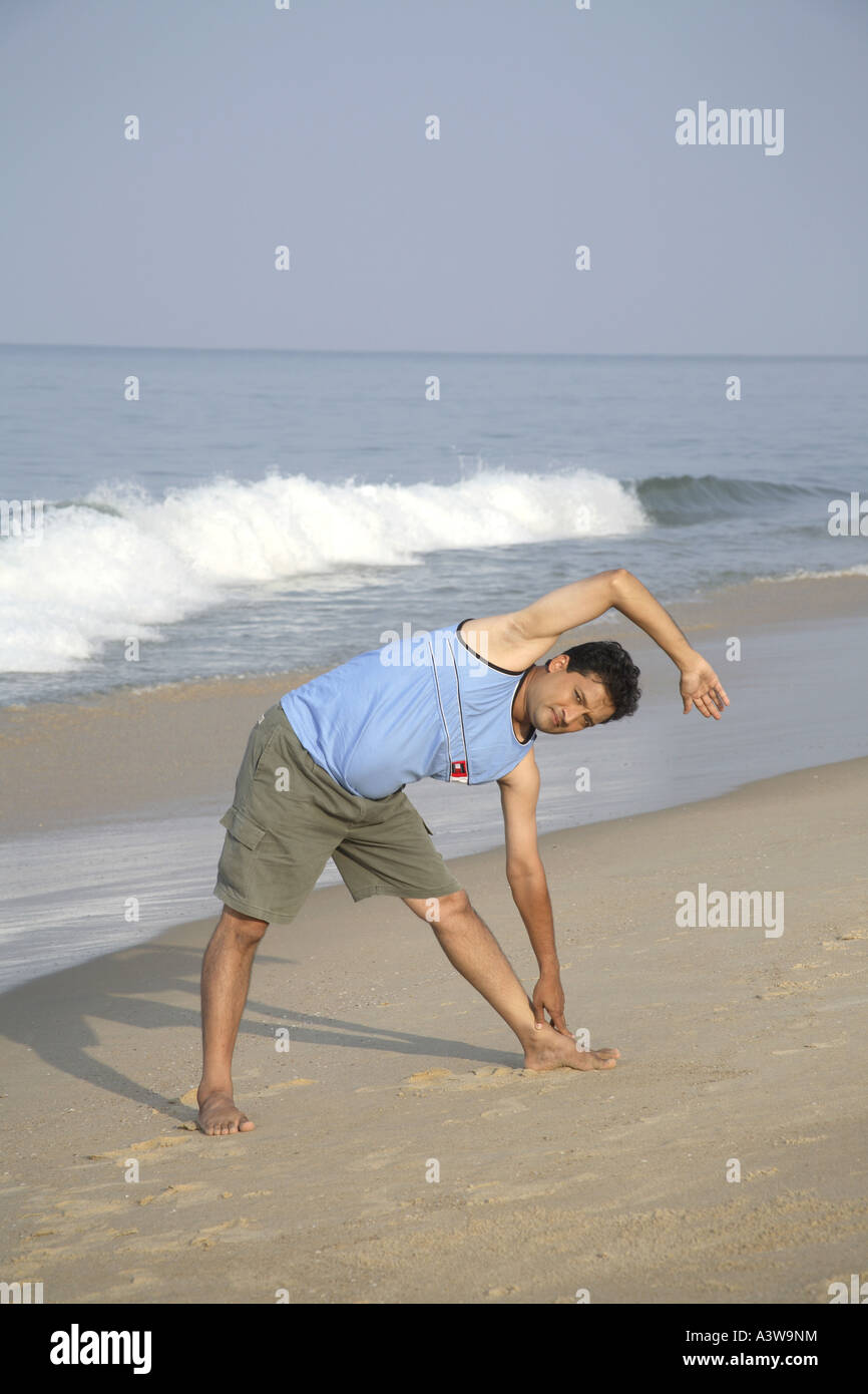 Indian man exercising on the beach - MR#703D Stock Photo - Alamy