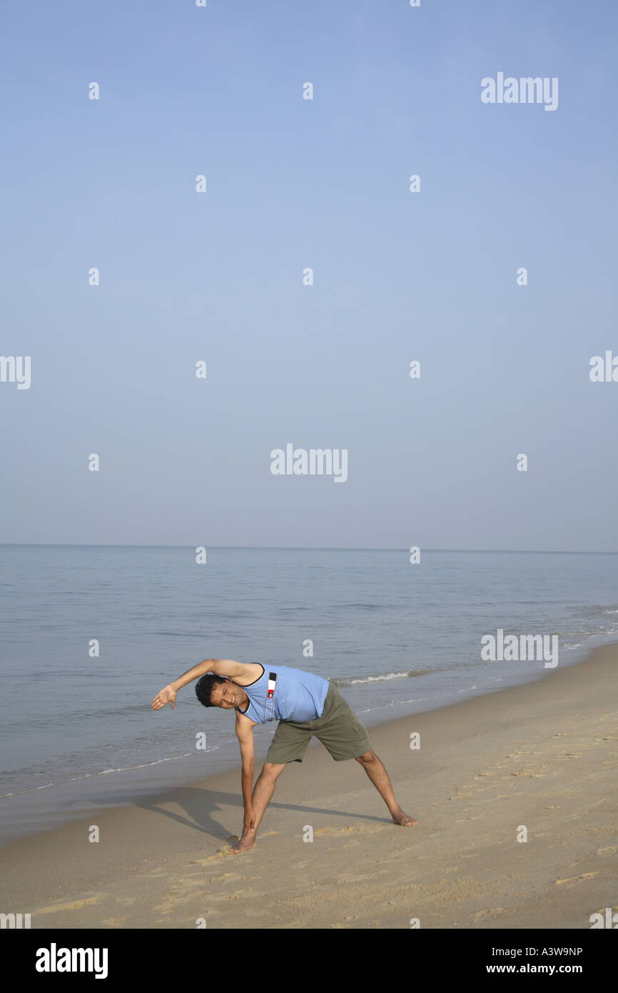 Indian man exercising on the beach - MR#703D Stock Photo - Alamy