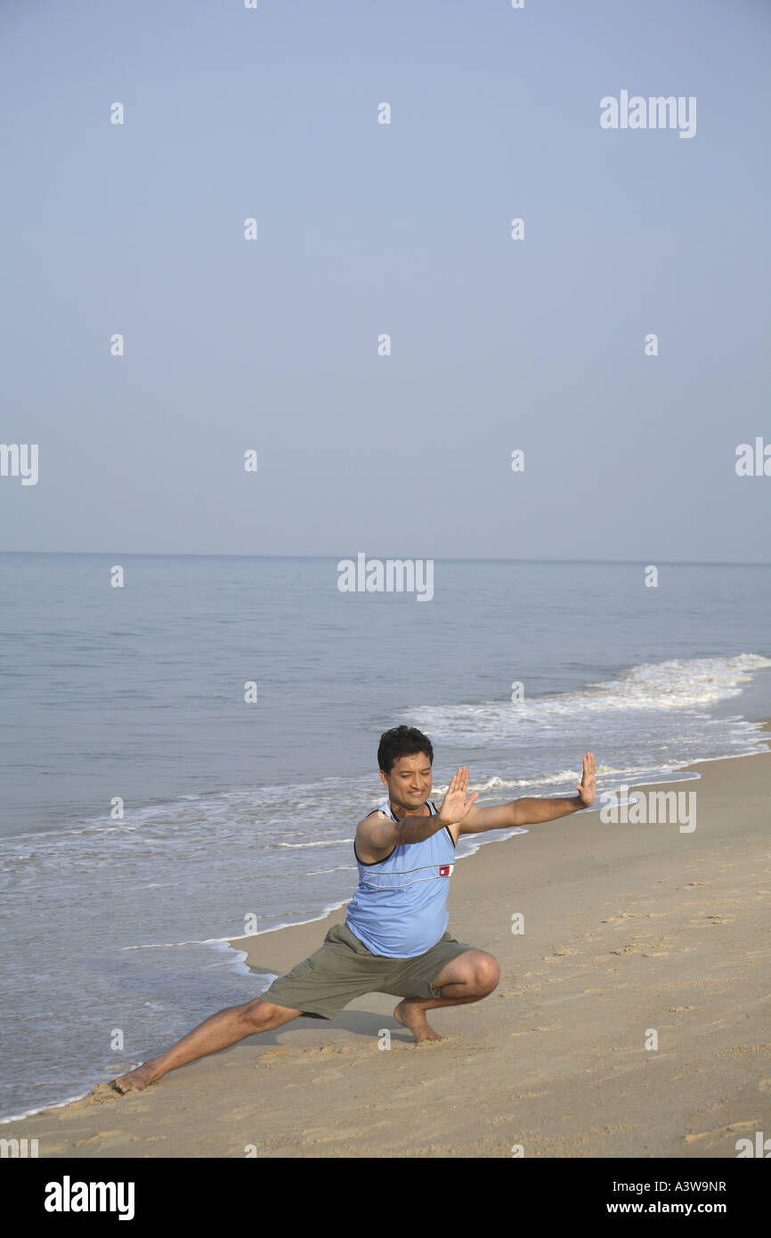 Indian man exercising on the beach - MR#703D Stock Photo - Alamy