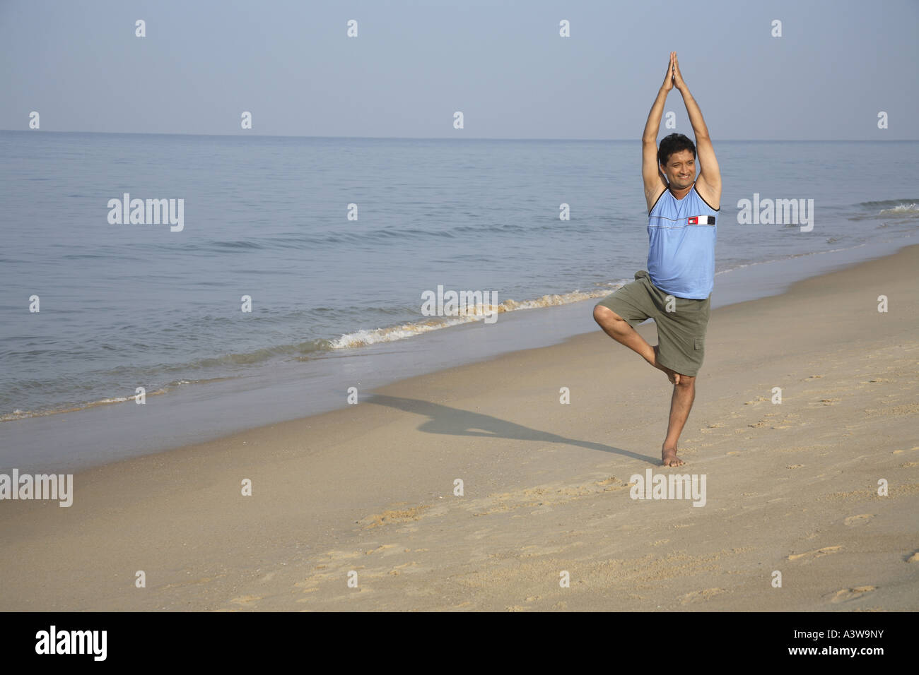 Indian man exercising on the beach - MR#703D Stock Photo - Alamy