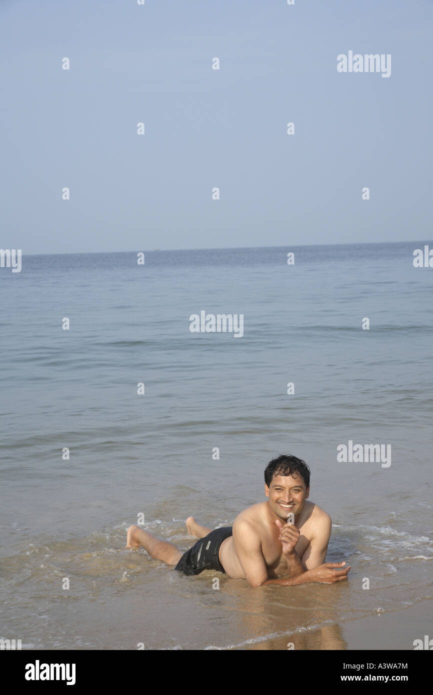 Bachelor on holiday enjoying sun sand sea on the beach Stock Photo - Alamy