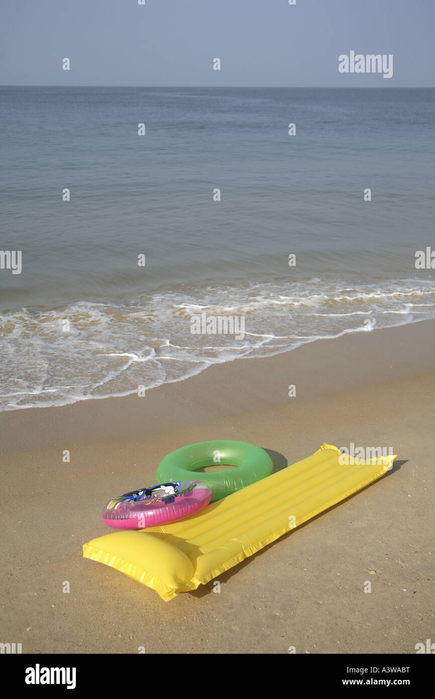 Plastic floaters and bed on beach Stock Photo - Alamy