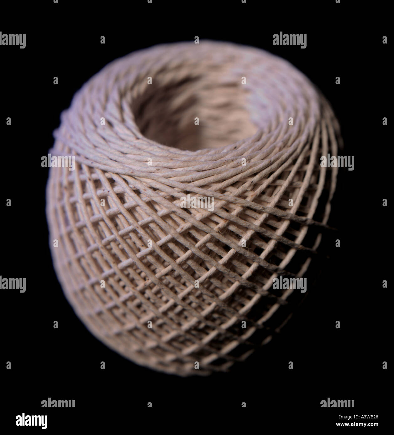 Ball of string still life with a black background Stock Photo - Alamy