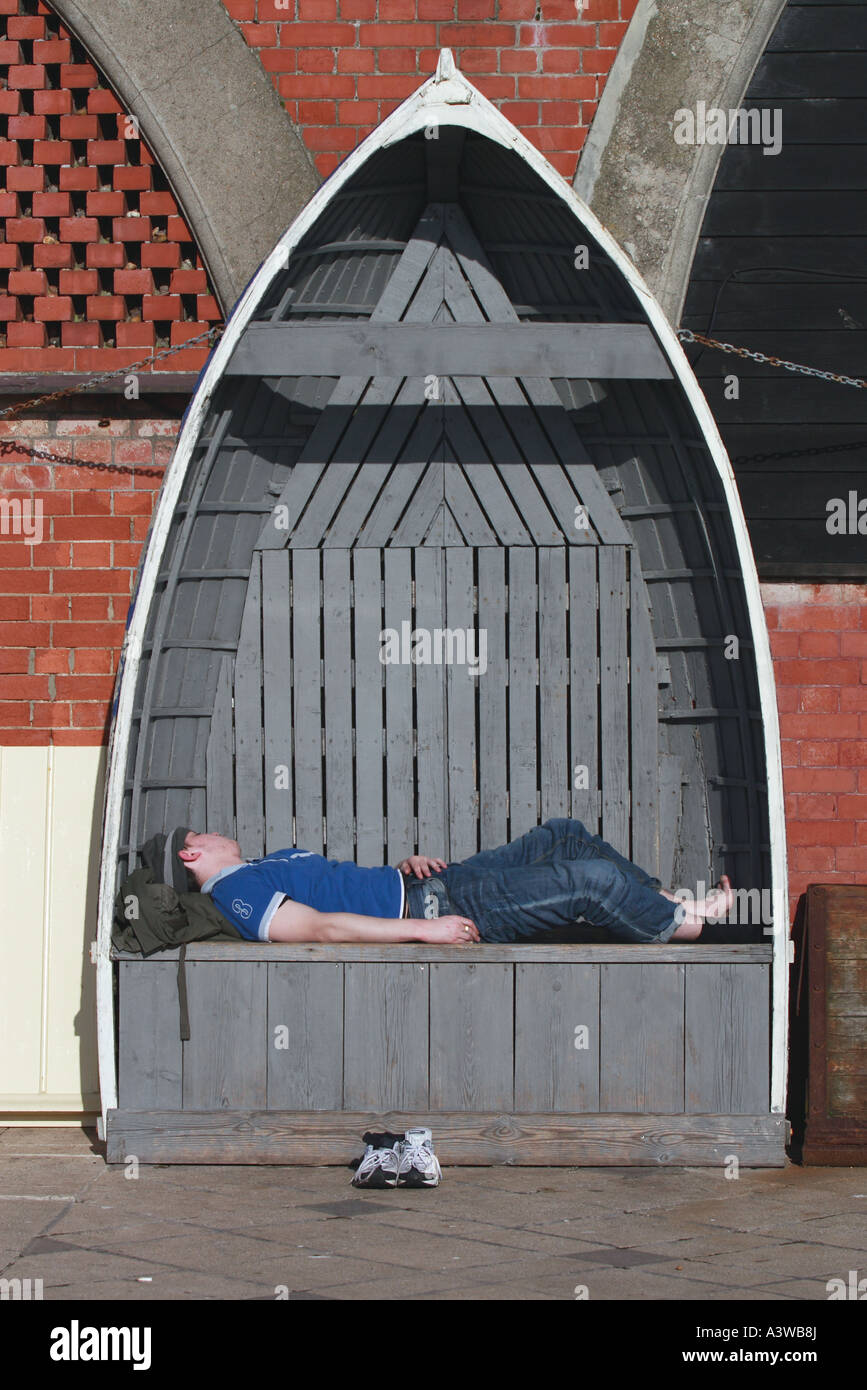 Sleeping in the sunshine on Brighton seafront Stock Photo - Alamy