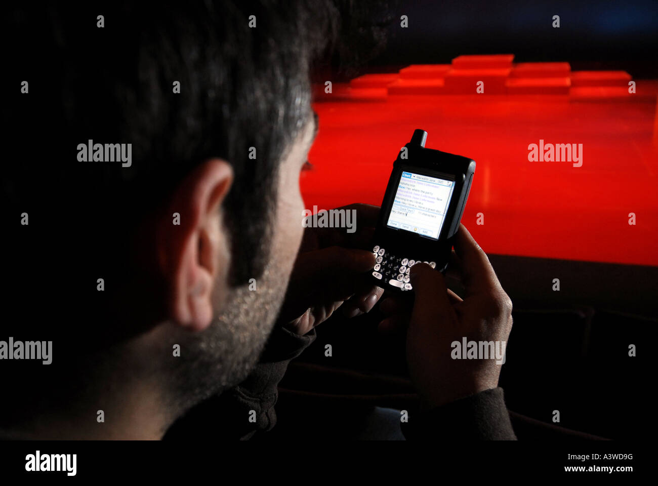 Person Texting during a theater performance. Cell phone rudeness Stock ...