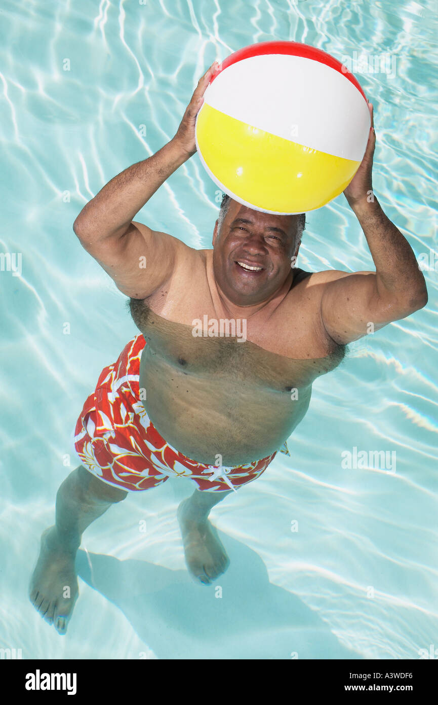 Senior with Beach Ball in Swimming Pool Stock Photo - Alamy