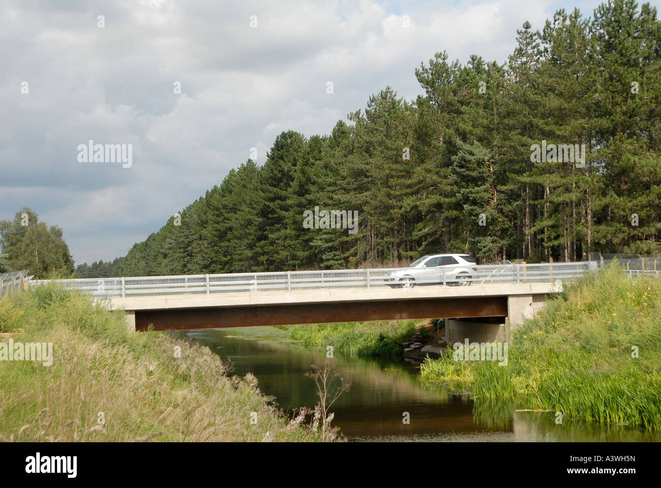 Car driving across a bridge spanning a stream in the uk Stock Photo - Alamy