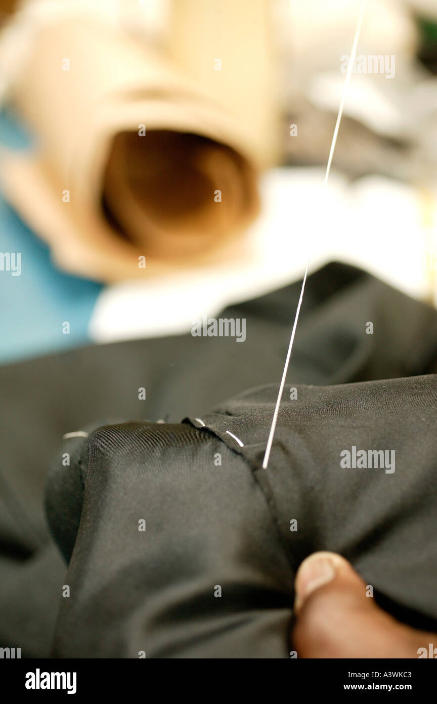 Stitching with a needle eye of sew Stock Photo - Alamy