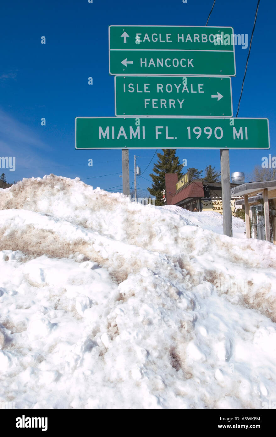 A road sign and snowbank in Copper Harbor Michigan shows its at the ...