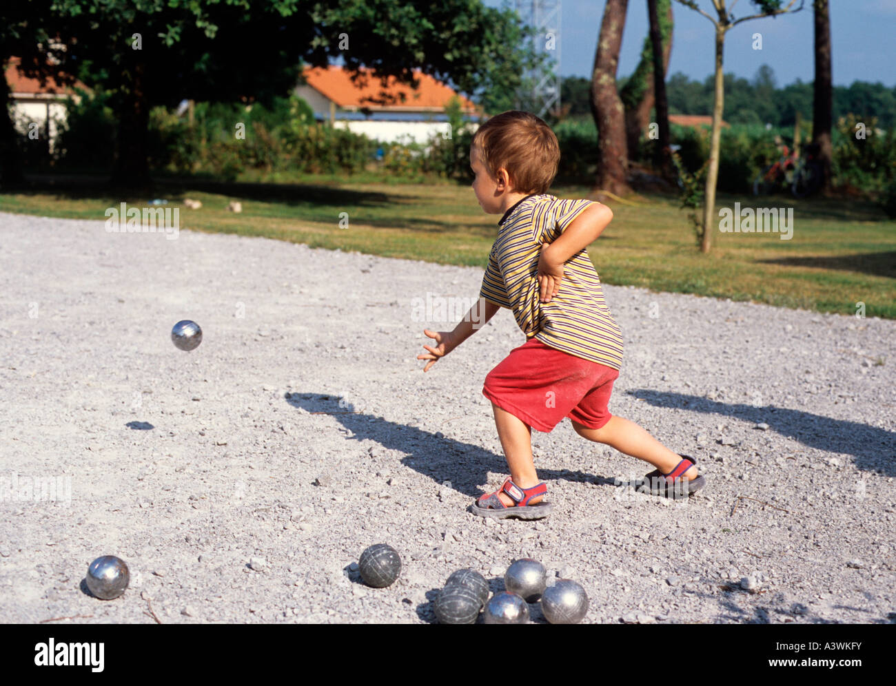 French boy child play playing boules Stock Photo - Alamy