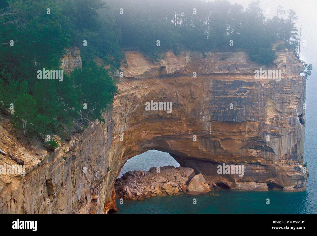 The Grand Portal rock formationin the fog at Pictured Rocks National ...