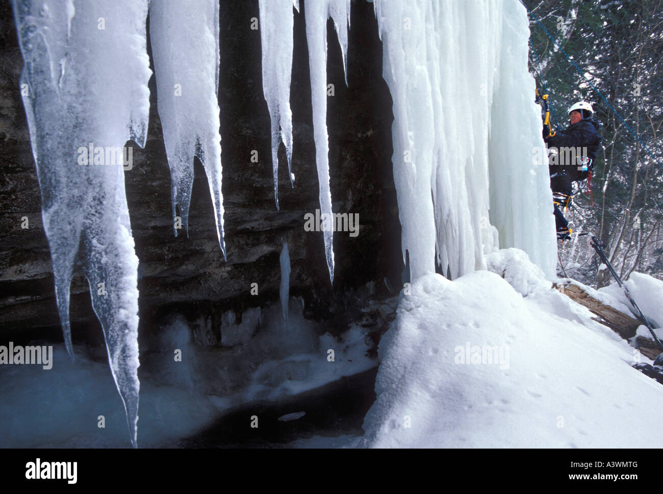 A female ice climber begins a climb on a frozen waterfall at Pictured ...