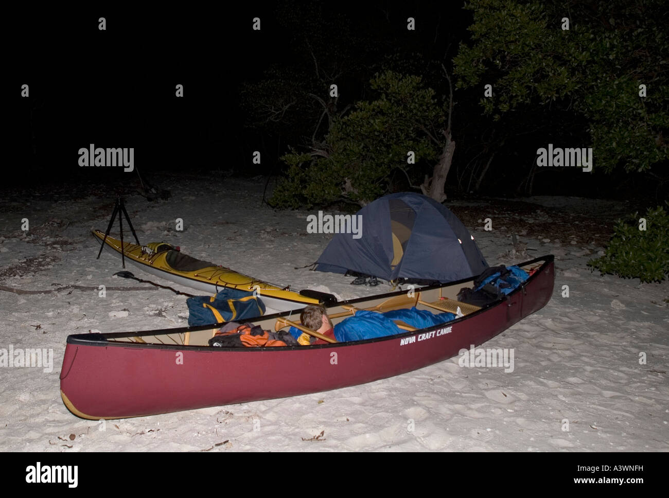 A backcountry camper prepares to sleep in his canoe on Round Key in the ...