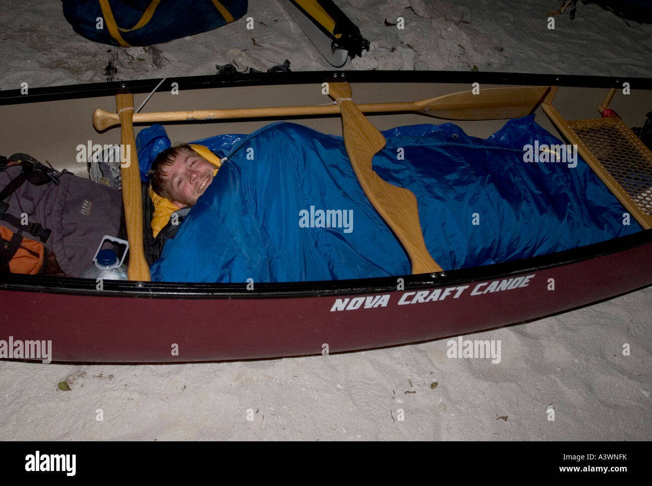 A backcountry camper prepares to sleep in his canoe on Round Key in the ...