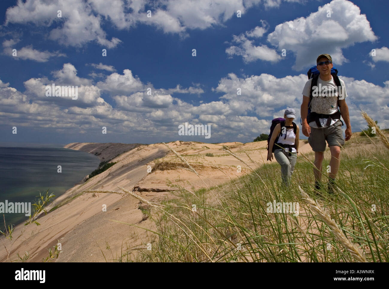 Backpackers climb a trail in the Grand Sable Dunes in Pictured Rocks ...