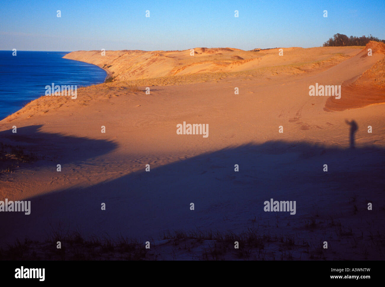 A backpacker s shadow is seen with the Grand Sable Dunes at dusk in ...