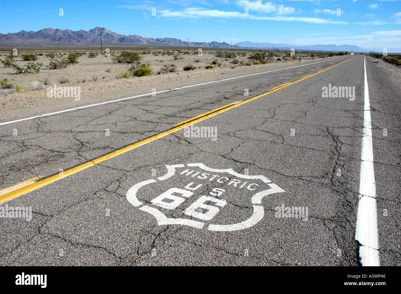Route 66 painted sign on roadway in high California Mojave desert near ...