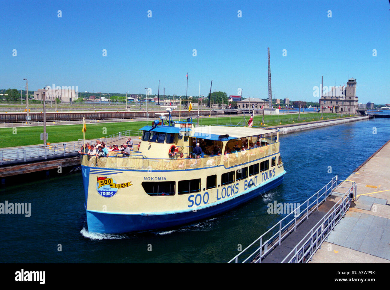 A TOUR BOAT MOVES OUT OF THE SOO LOCKS ON THE SAINT MARYS RIVER AND ...