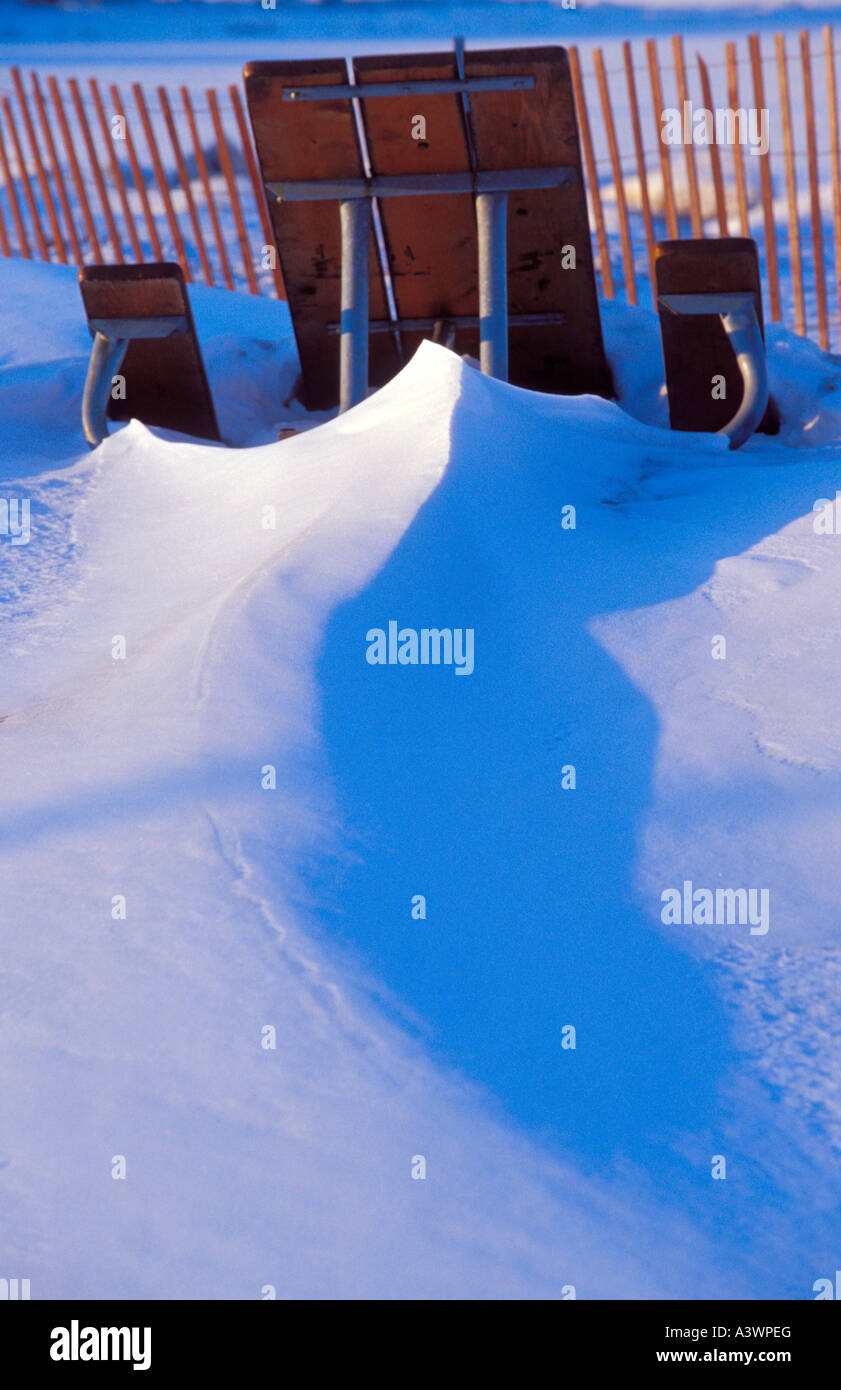 A SNOW DRIFT SURROUNDS A PICNIC TABLE NEAR A SNOW FENCE IN MARQETTE ...