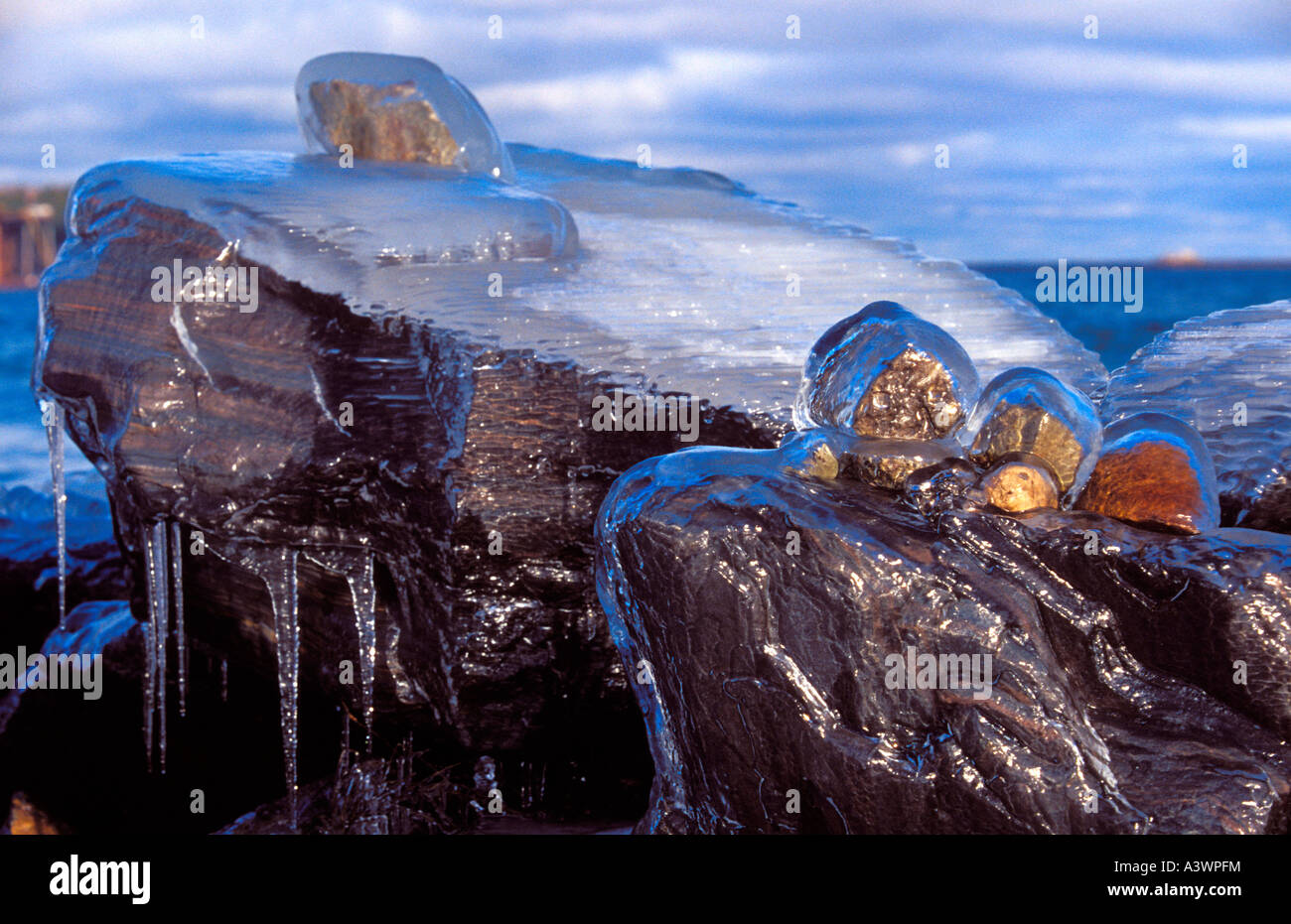 ROCKS ON THE SHORES OF LAKE SUPERIOR ARE COATED WITH ICE FOLLOWING A ...