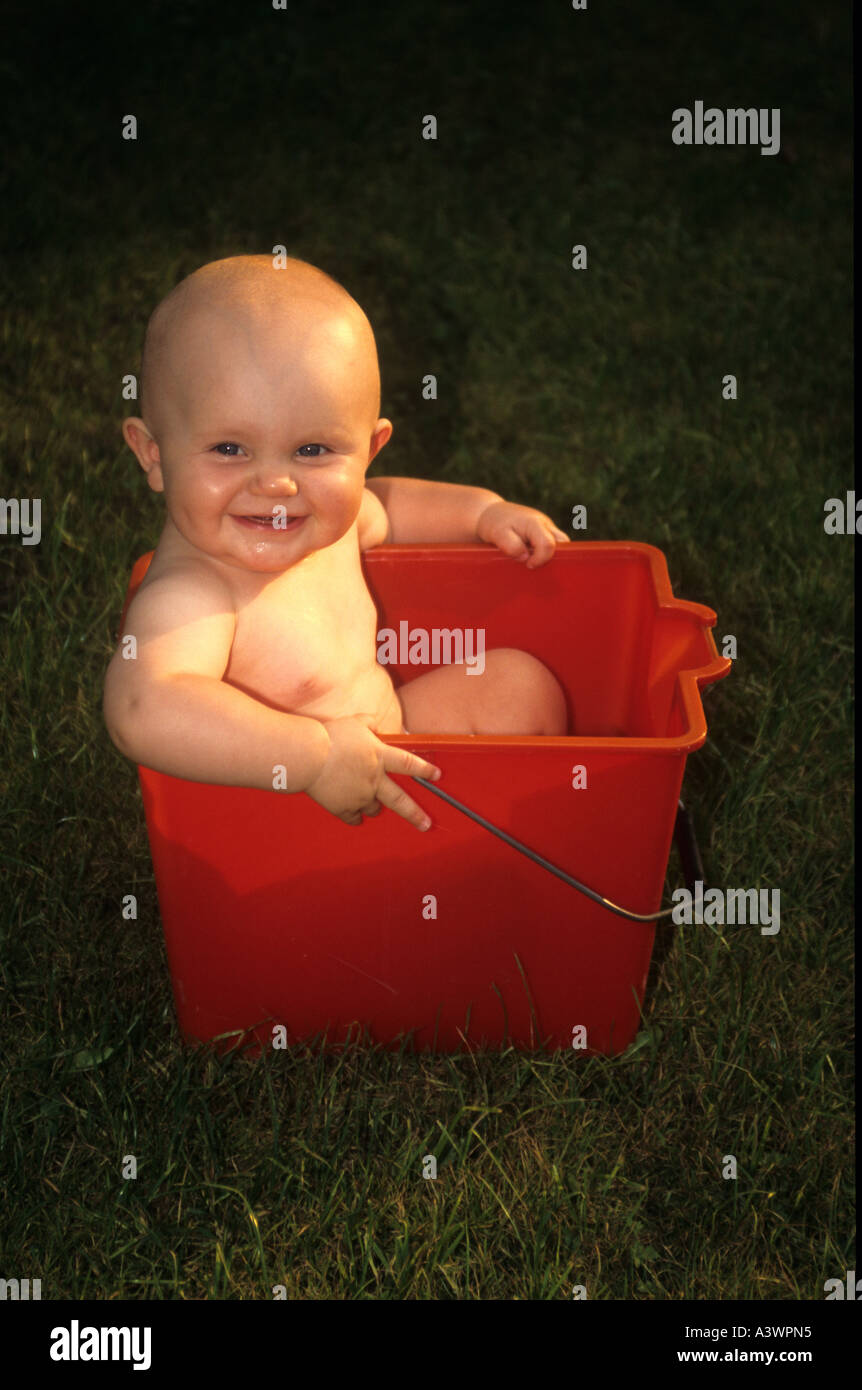 Baby Boy Relaxing In A Bucket Stock Photo - Alamy