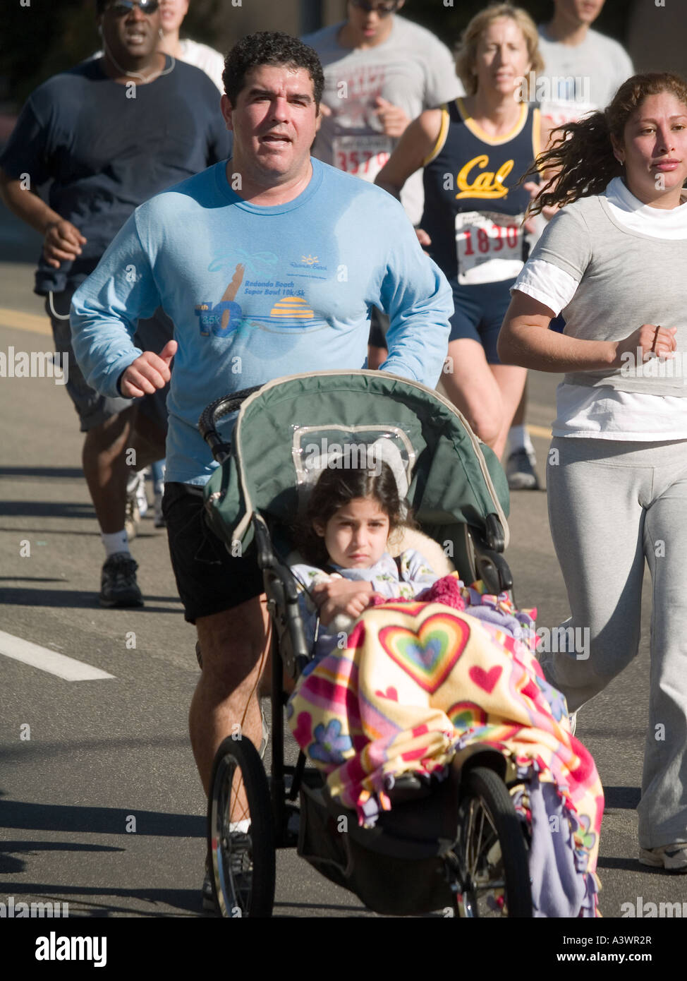 Heavy set white man pushes daughter in baby carriage in race Stock ...