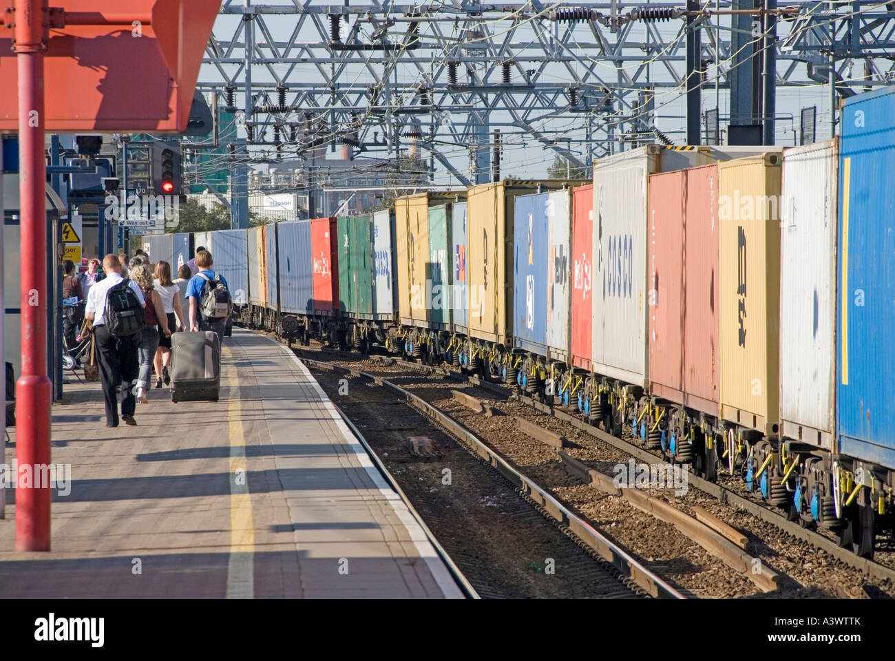 Freight train loaded with mixed brands of shipping containers passing ...