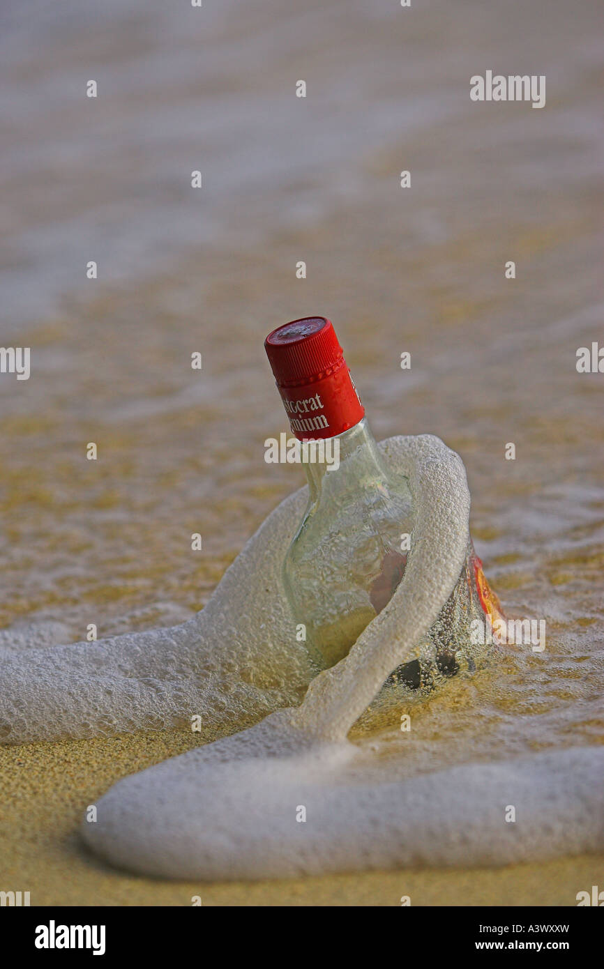 An empty bottle get hit by a wave. - India Stock Photo - Alamy